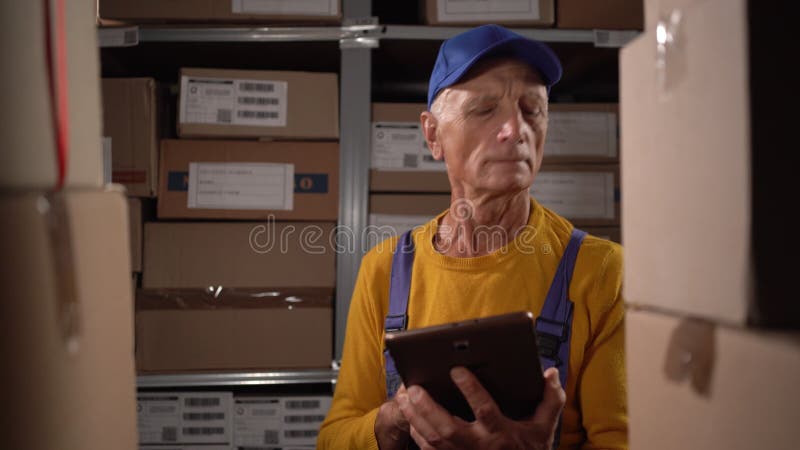 Successful Elderly Employee Checking Inventory, Writing in Tablet ...