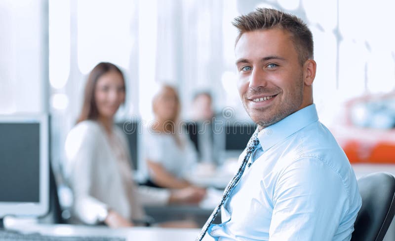 Successful Employee Sitting Behind a Desk and Looking at the Camera ...