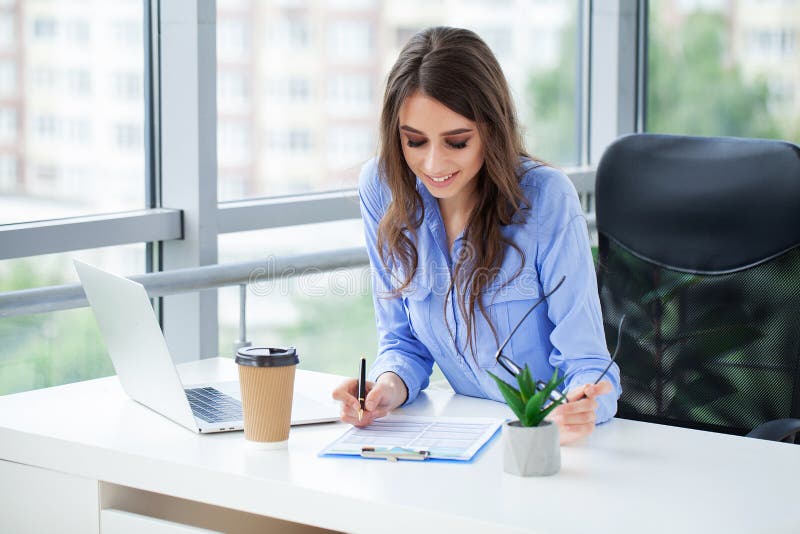 Successful Female Working a Laptop Computer in Office. Stock Image ...