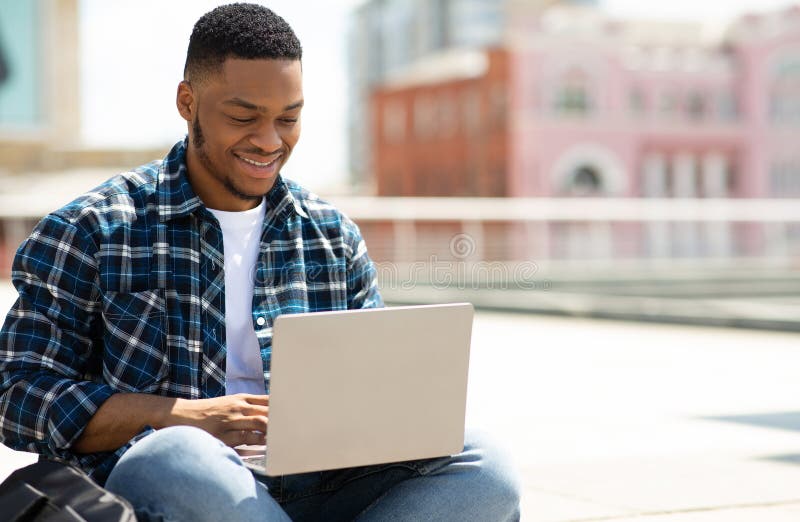 Glad Black Man Using Laptop, Sitting in the City Downtown Stock Image ... Glad Black Man Using Laptop, Sitting in the City Downtown Stock Image ...