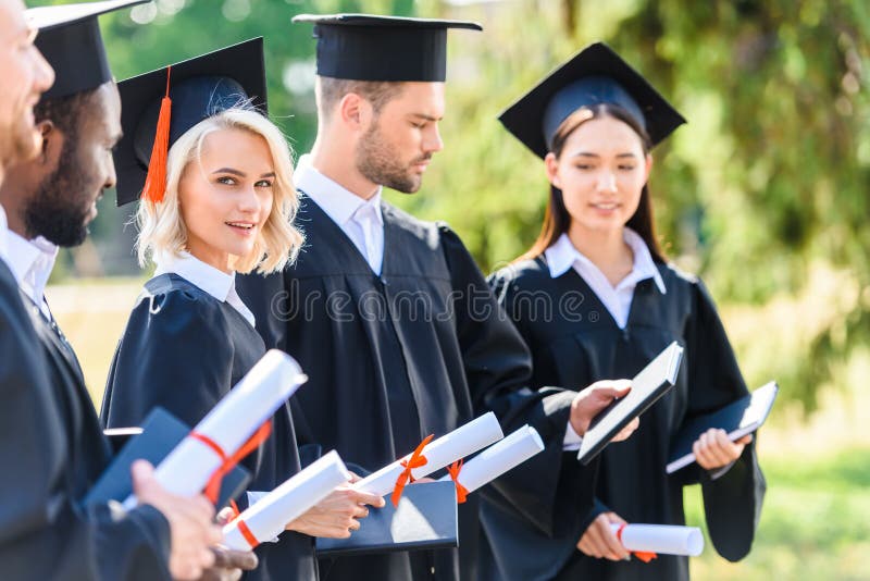 Successful Graduated Students in Capes and Hats Holding Stock Photo ...