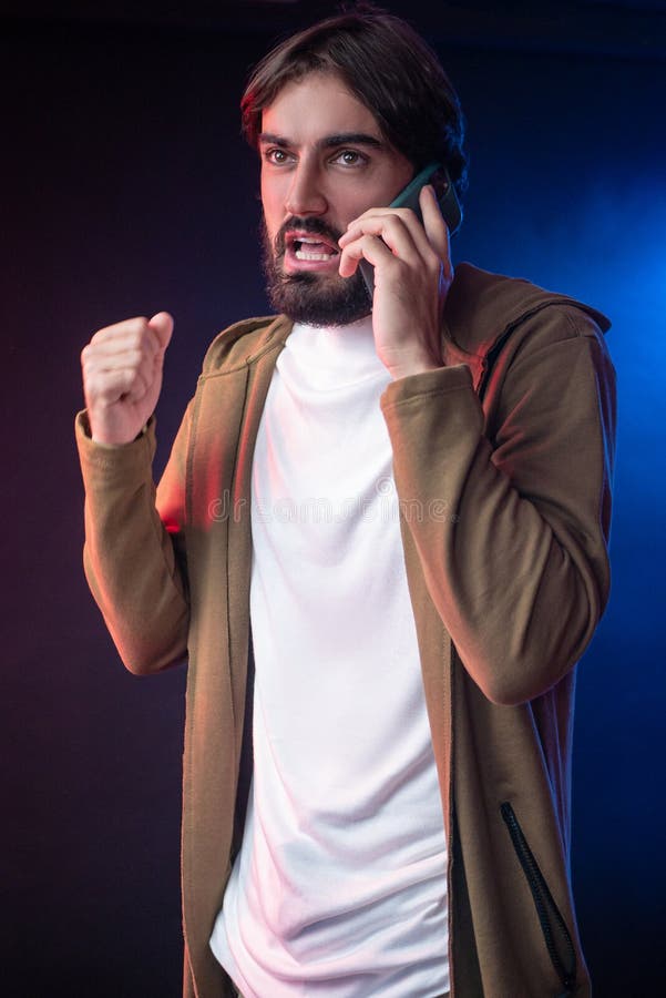 A Successful Guy Talks on the Phone Showing Emotions Stock Image ...