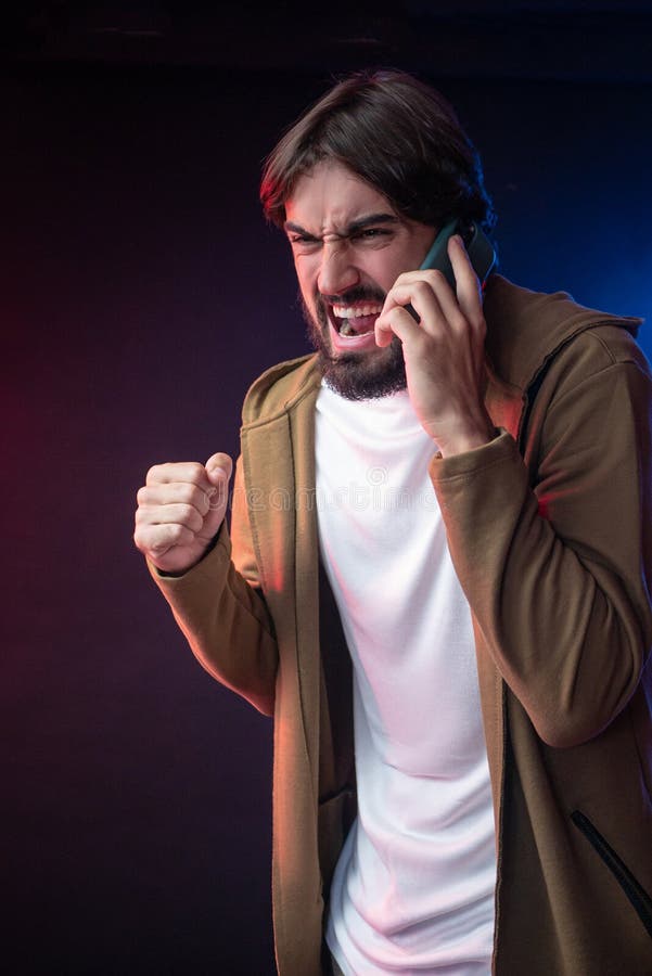 A Successful Guy Talks on the Phone Showing Emotions Stock Photo ...