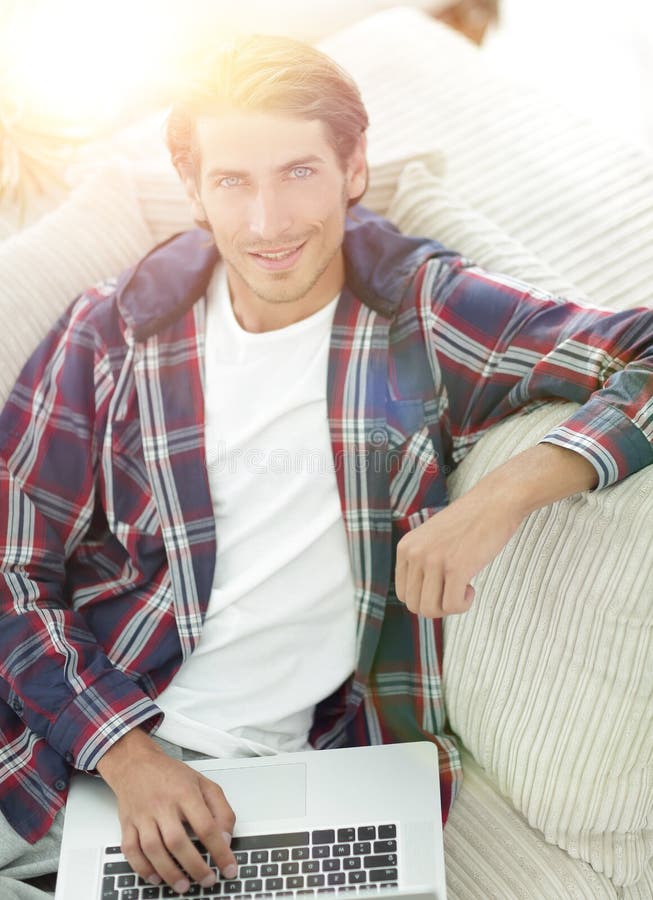 Successful Guy Working on Laptop and Looking at Camera. View from Above ...