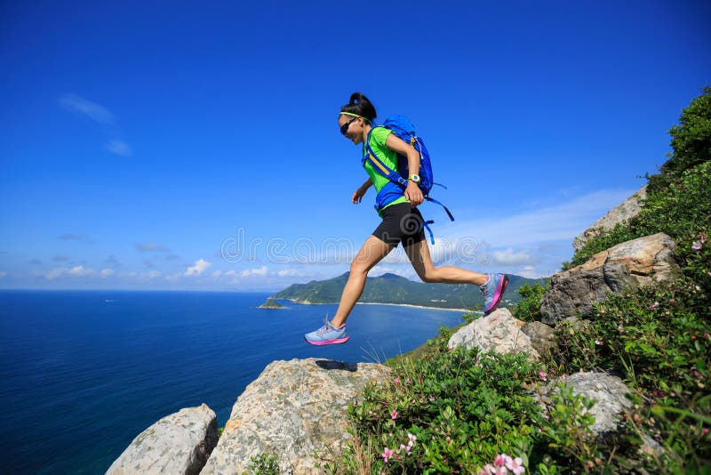 Hiker Running on Seaside Mountain Peak Rock Stock Photo - Image of ...