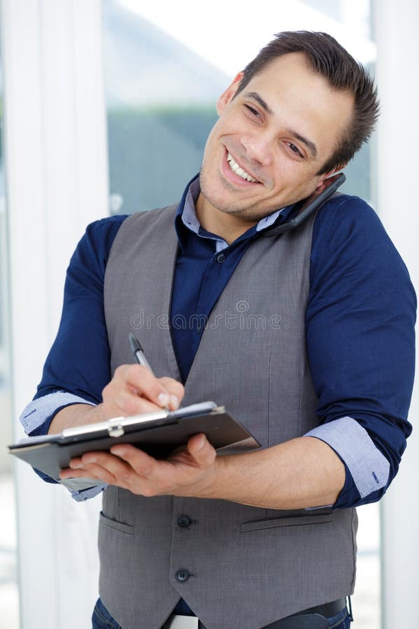 Successful Man with Clipboard Smiling into Camera Stock Image - Image ...