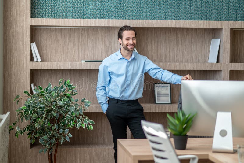 A Successful Man Standing in the Office and Looking Confident Stock ...