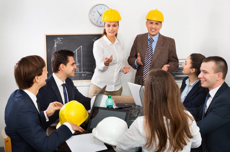 Successful Professionals with Laptops and Helmets Having Working Stock ...