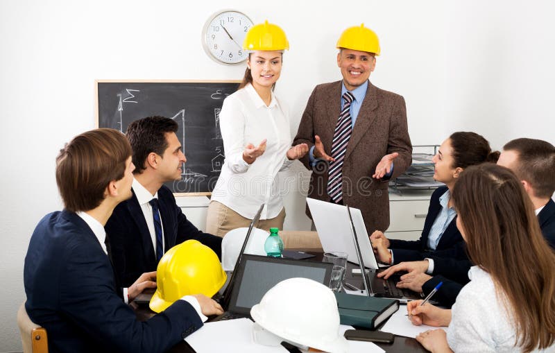 Successful Professionals with Laptops and Helmets Stock Image - Image ...