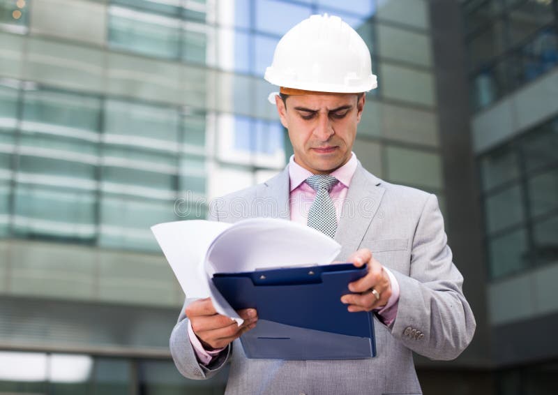 Serious Manager Reading Papers Stock Photo - Image of large, emotion ...