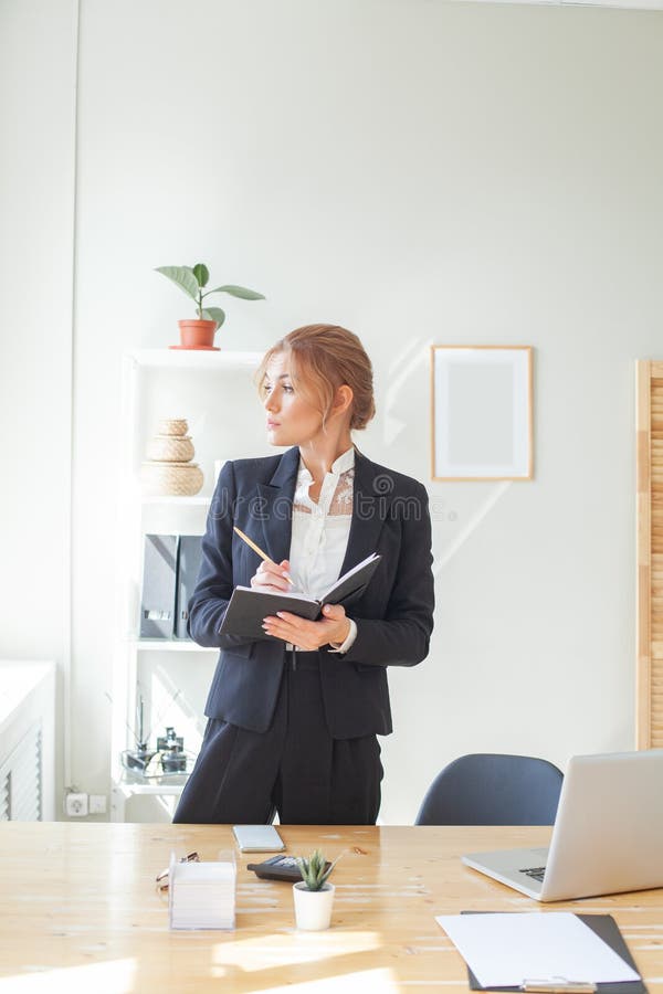 Successful Smart Businesswoman Using Laptop while Doing Some Paperwork ...