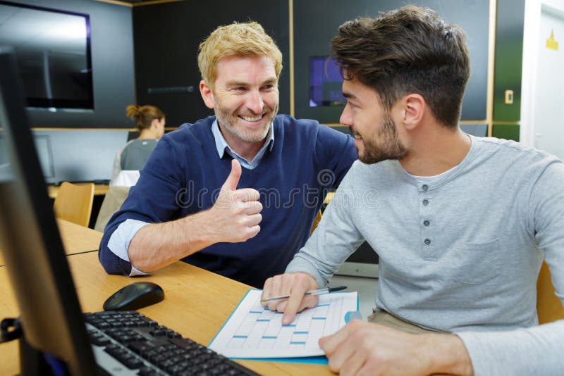 Successful Teacher in Class Holding Thumbs Up with Student Stock Image ...