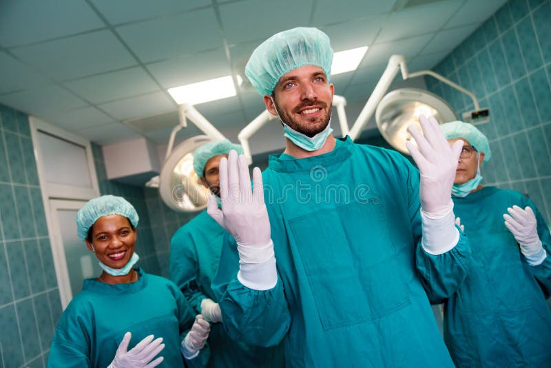 Successful Team of Surgeon Standing in Operating Room, Ready To Work on ...