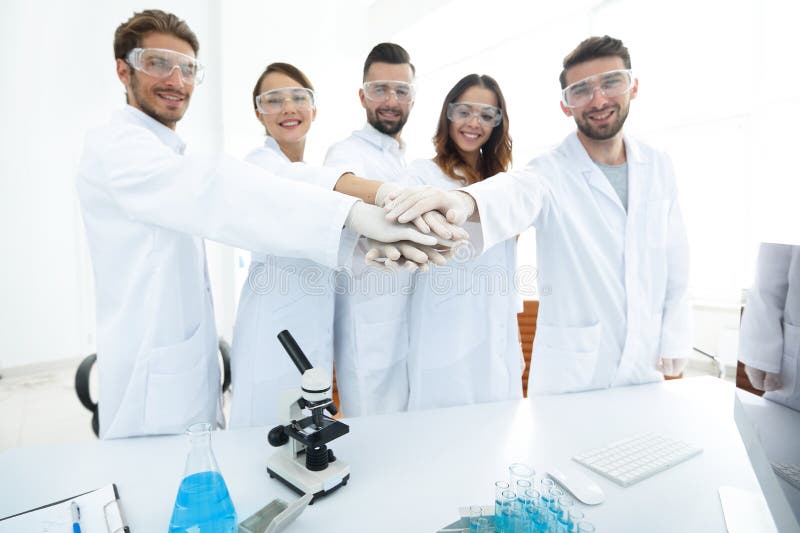 Successful Team of Young Scientists with Hands Clasped Together. Stock ...
