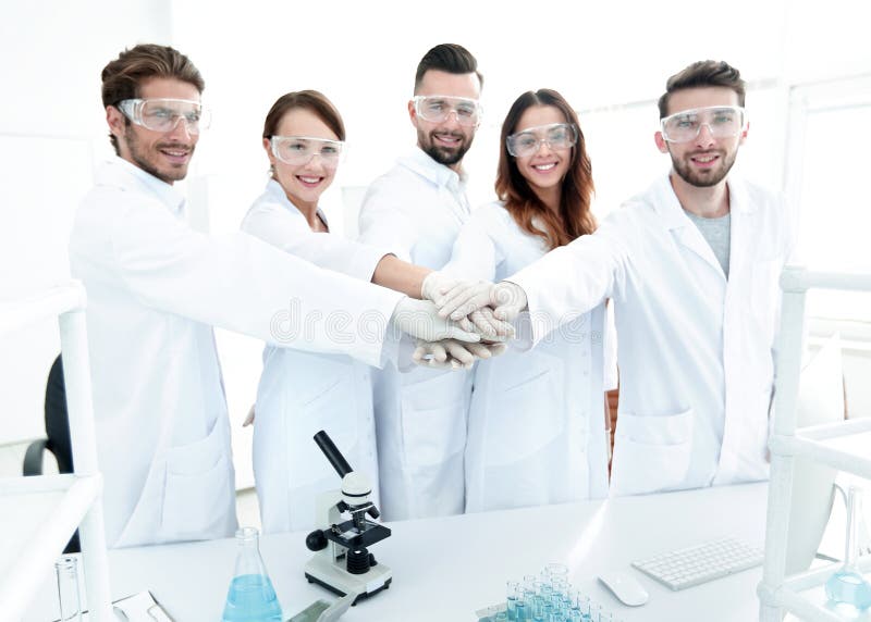Successful Team of Young Scientists with Hands Clasped Together. Stock ...