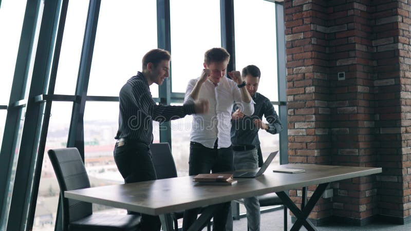 Successful Teamwork of Three Colleagues with Laptops in the Office ...