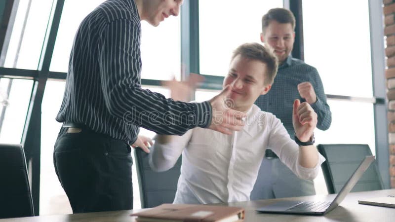 Three Successful Male Coworkers Collaborating on a Project with Their ...