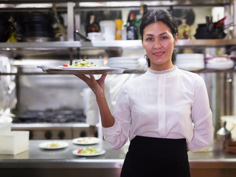 Successful Waitress Standing in Restaurant Kitchen with Ordered Meals ...