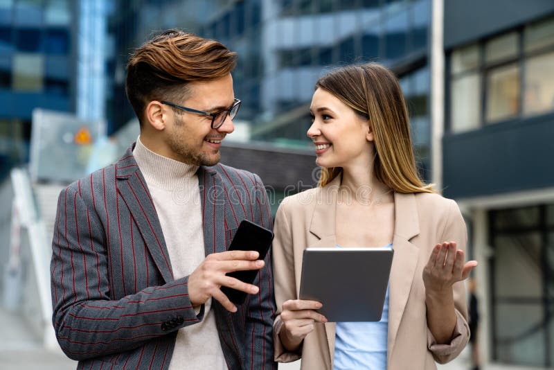 Successful Young Business People Talking, Working Together in Front of ...