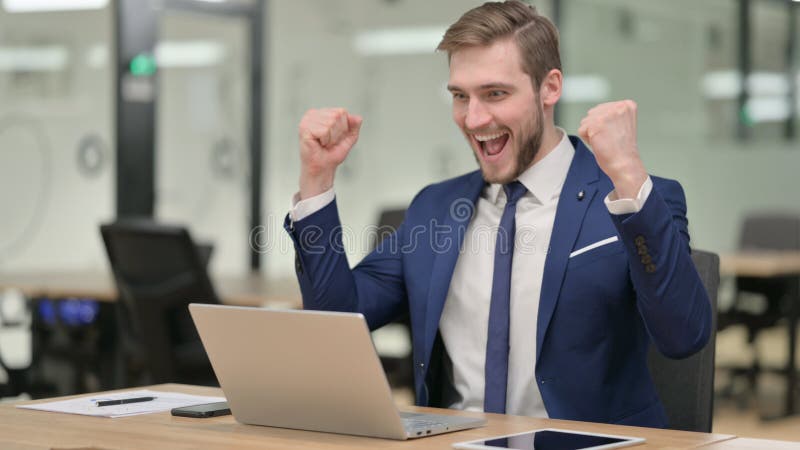 Businessman Celebrating on Laptop at Work Stock Photo - Image of ...