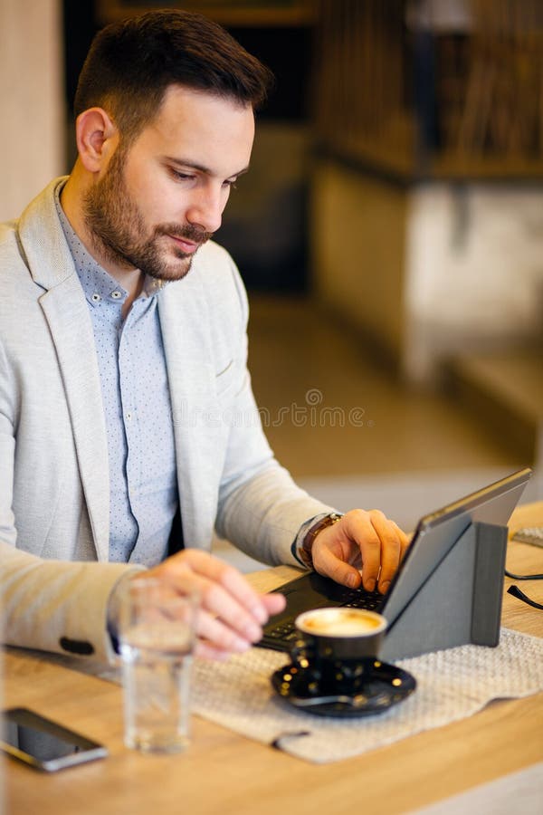 Successful Young Businessman Using a Tablet in a Cafe Stock Photo ...
