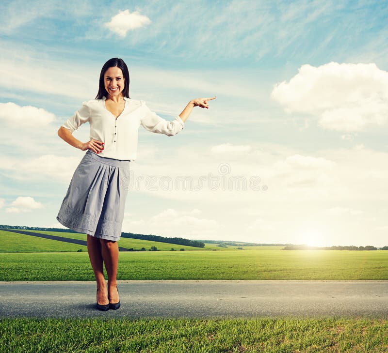 Successful Young Woman Pointing at Something Stock Image - Image of ...