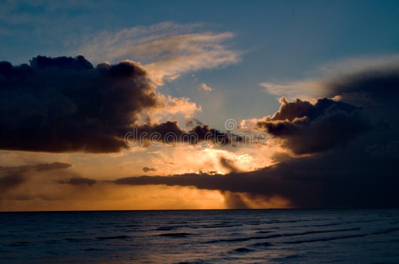 The Last Rays of the Sun Blocking by Clouds Stock Photo - Image of ...