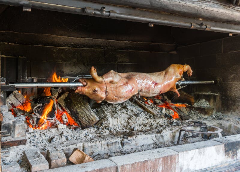 Suckling Pig is Roasted on a Spit Over Open Fire on Stove Stock Photo ...