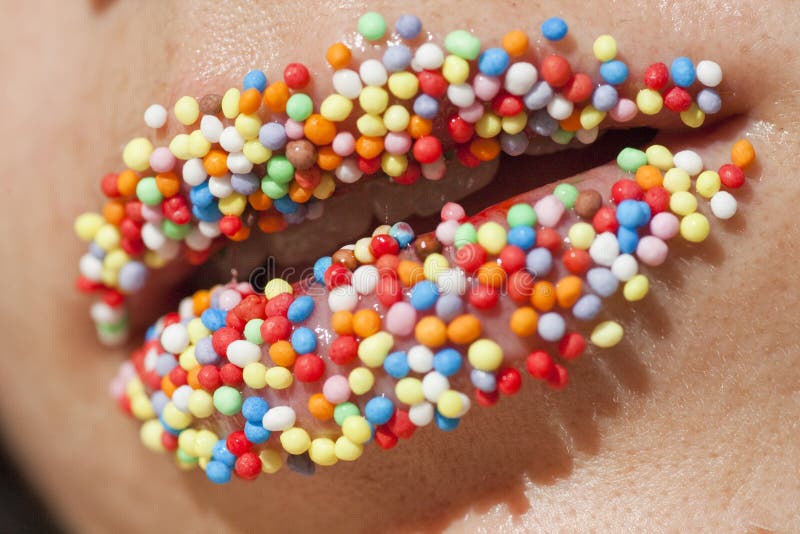 Sugar balls in woman lips stock photo. Image of woman - 105983028