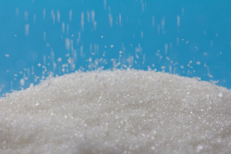Sugar on a blue background stock image. Image of macro - 104187159