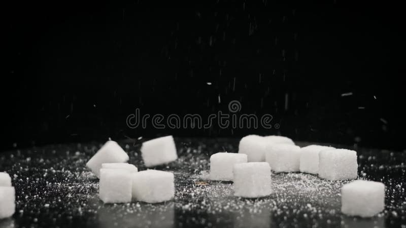 Sugar Cubes Fall on Rotating Table on Black Background in Slow Motion ...