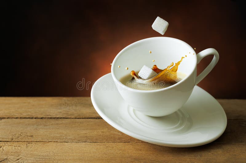 Sugar Cubes Falling into Flying Cup of Coffee with Splashes on Table ...
