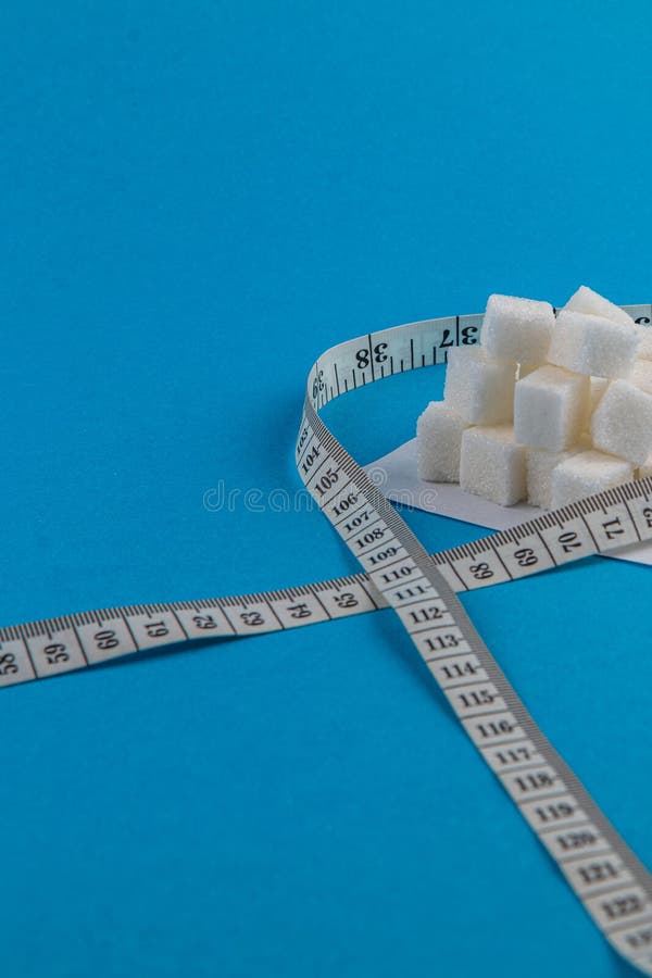 Measuring Sugar Cubes on a Blue Background with a Ruler Present Stock ...