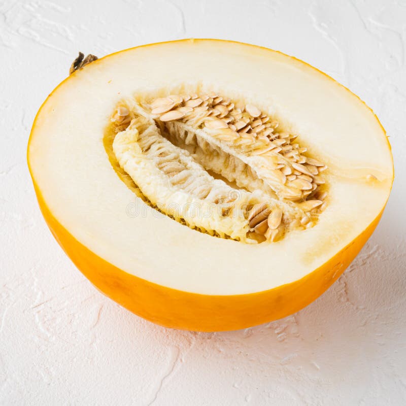 Sugar Melon Cut in Half, on White Stone Table Background, Square Format ...