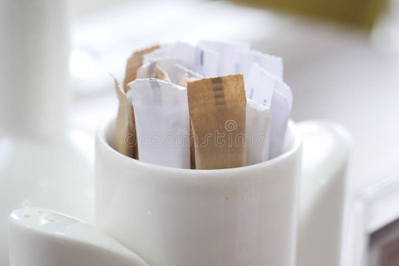 Sugar Packets in a Container at a Dining Table Stock Image - Image of ...