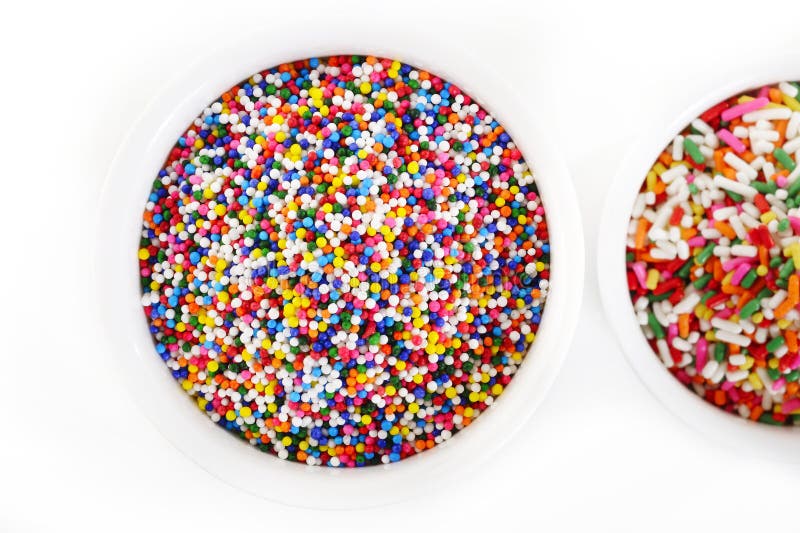 Sugar Spreading and Rainbow Sprinkles in Cup on White Stock Image ...