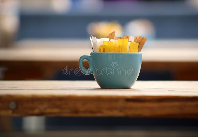 Sugar and Sweetener Packets in a Cup Stock Photo - Image of front ...