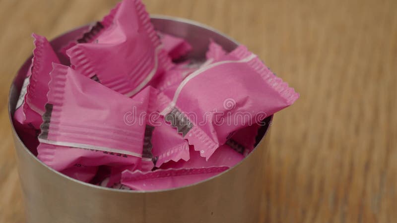Sugar Wrappers in a Bowl on a Wooden Table Stock Video - Video of ...