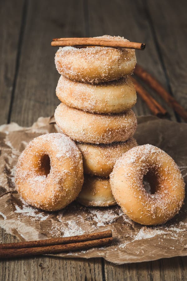 Sugared Stacked Mini Donuts with Cinnamon on a Wooden Table Stock Image ...