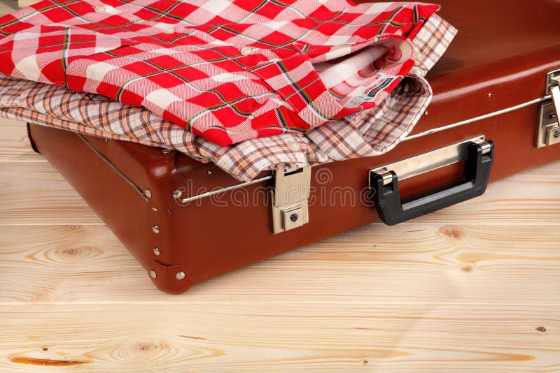 Suitcase and Clothes on Wooden Background Stock Photo - Image of ...