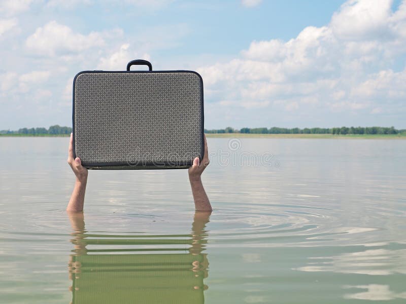 Suitcase in Hand Above the Water Stock Image - Image of migration ...