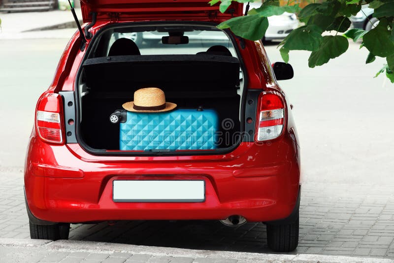 Suitcase and Hat in Car Trunk Stock Photo - Image of luggage, family ...