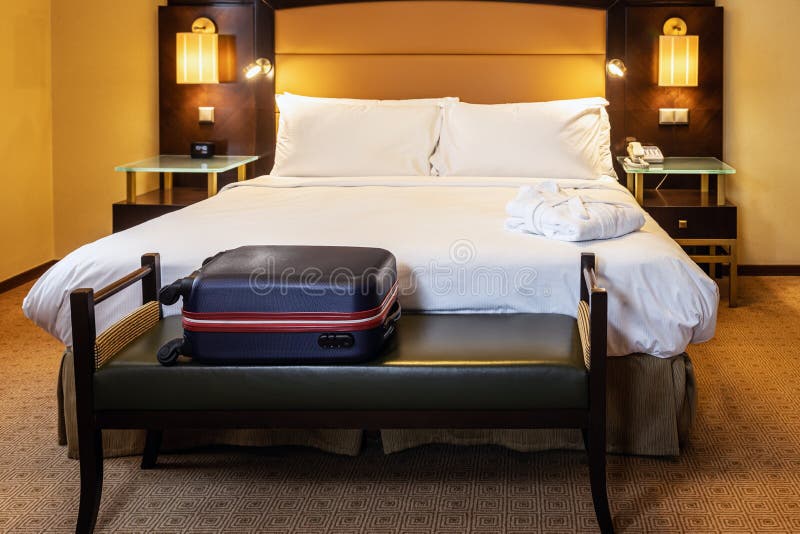 Suitcase Stands by the Bed in the Hotel Room Stock Image - Image of ...