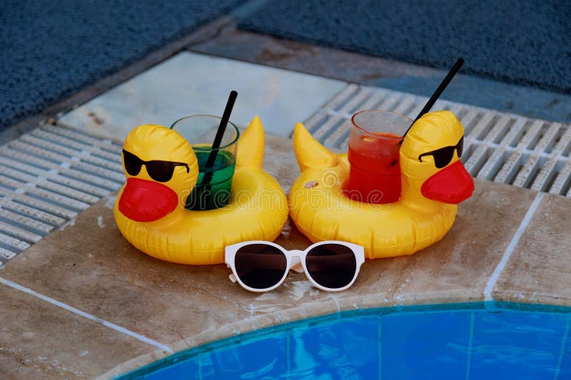 Summer Beach Composition with Inflatable Mini Ducks and Cold Drinks on ...