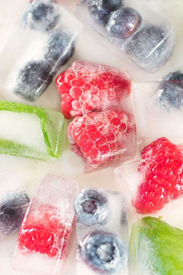 Summer Berries. Raspberries, Blueberries and Mint Leaves in Ice Cubes ...