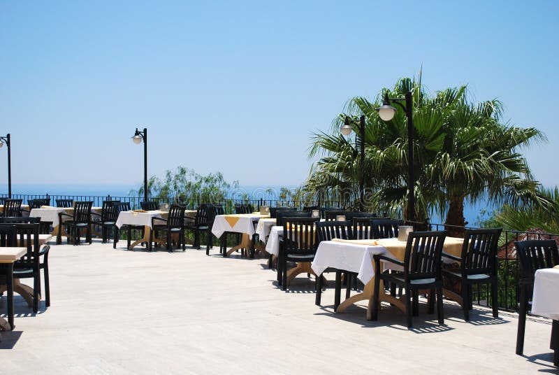 Outdoor Cafe Overlooking Ocean Stock Image - Image of ocean, chairs ...