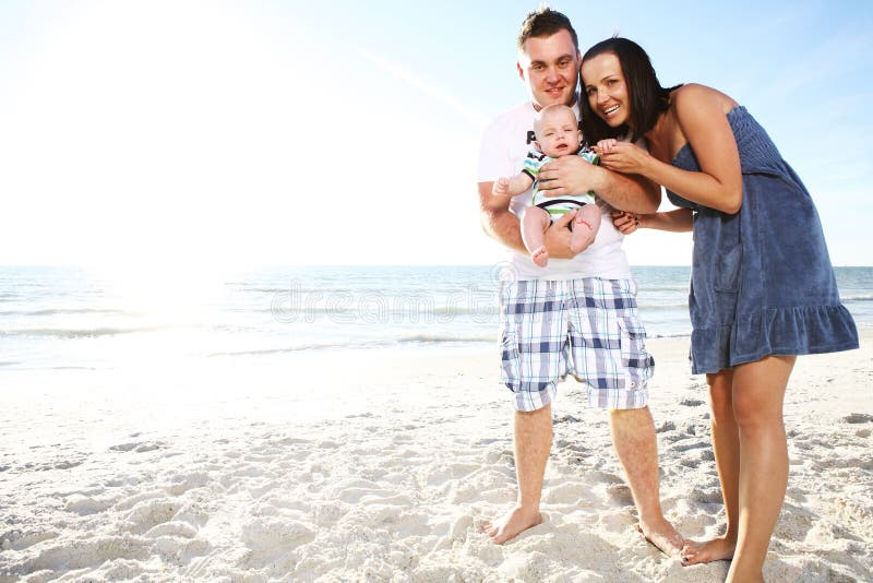 Happy Family of Three People Walking on Beach Along Ocean Stock Image ...
