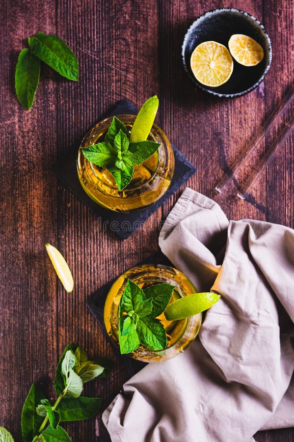 Summer Detox Drink with Tea, Lime and Mint in Glasses on the Table Top ...