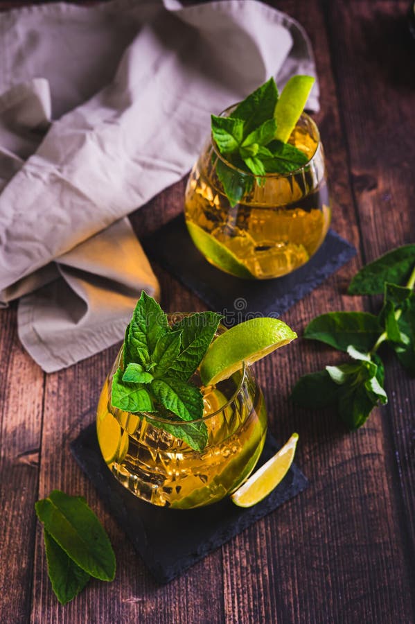 Summer Detox Drink with Tea, Lime and Mint in Glasses on the Table ...