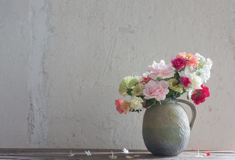 Summer Flowers in Ceramic Jug on Wooden Table on Background Old White ...